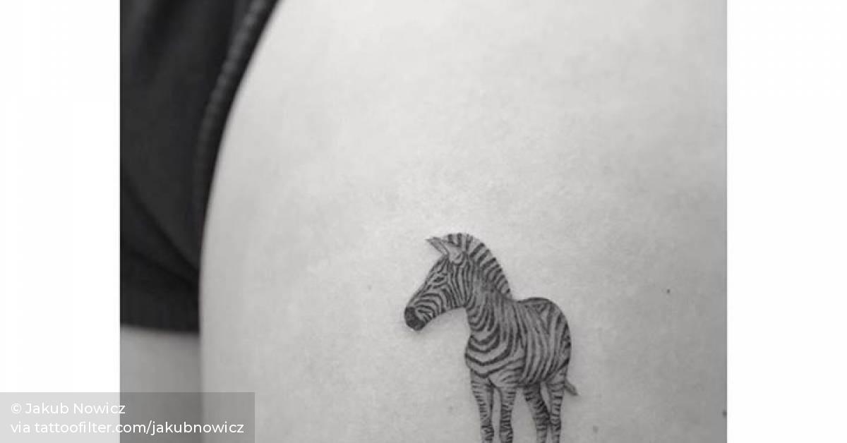 Fine line zebra tattoo on the left thigh.