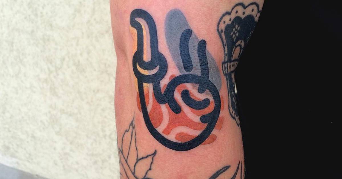 Smoking pipe tattoo on the right arm.