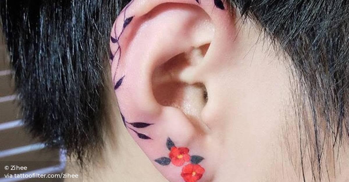 Flower tattoo on the right ear.