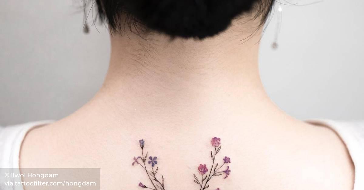 Flower wreath tattoo on the upper back.
