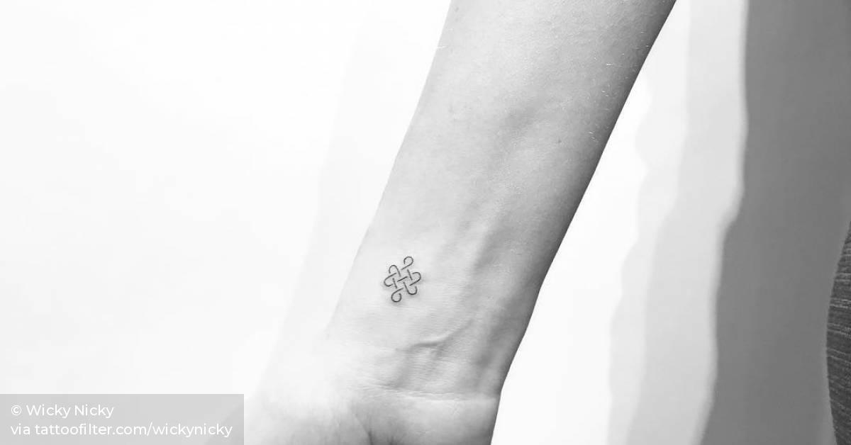 Endless knot tattoo on the inner wrist.