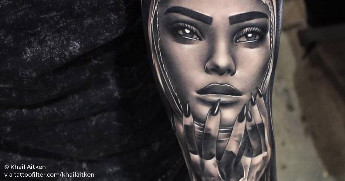 Black and grey nun tattoo on the left inner forearm.