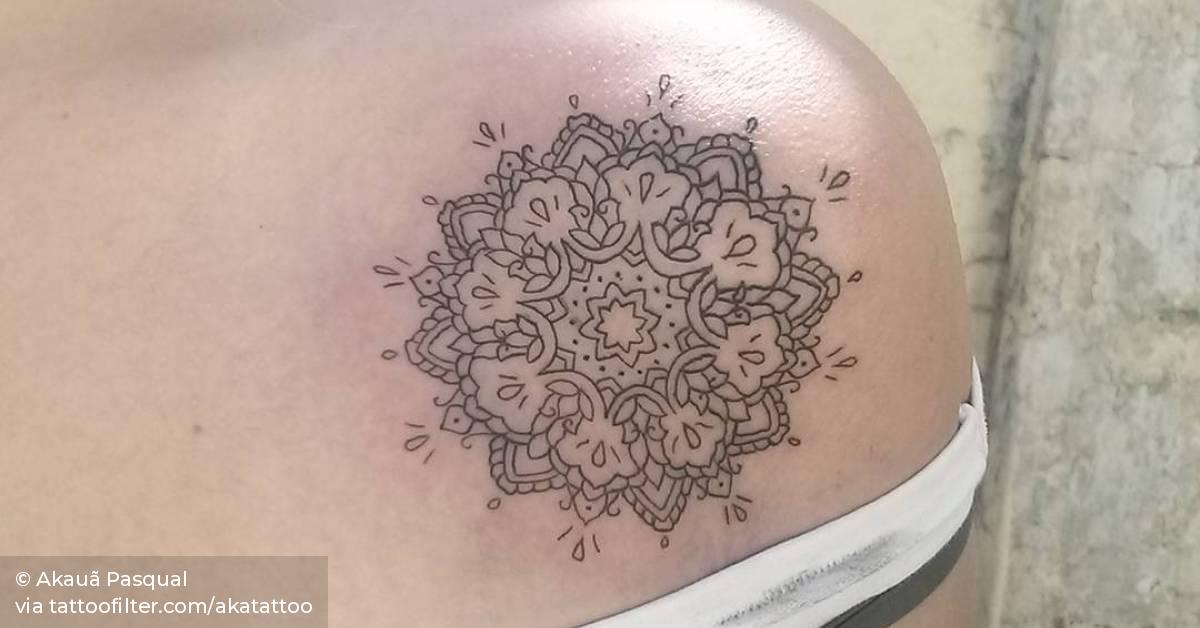Fine line style ornamental mandala on the shoulder.