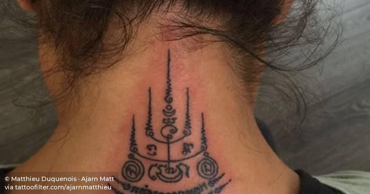 Sak Yant tattoo on the back of the neck.