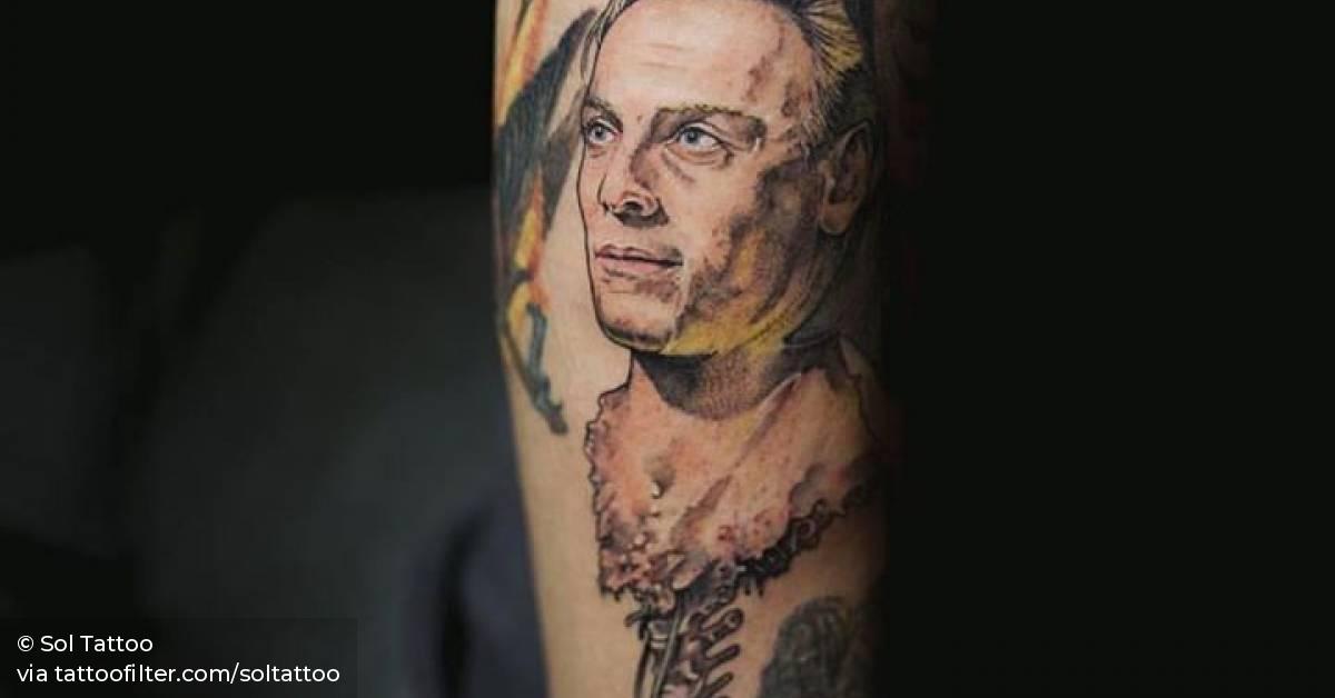 Prometheus' David 8 head tattoo on the forearm.