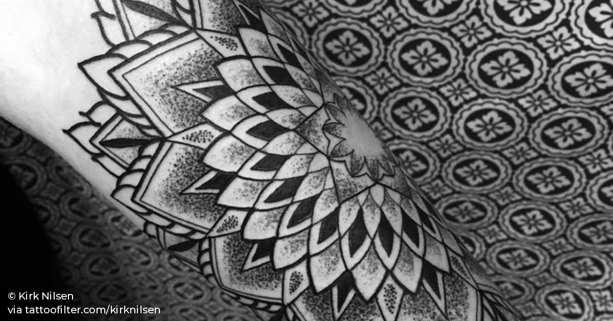 Ornamental/dotwork style mandala on the forearm.