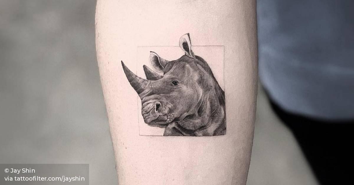 Rhino tattoo on the inner forearm.