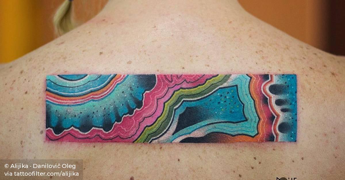 Abstract tattoo on the upper back.