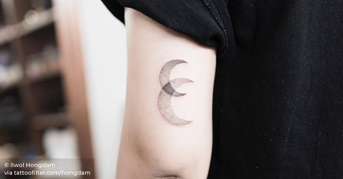 Dotwork style moons on the back of the left arm.