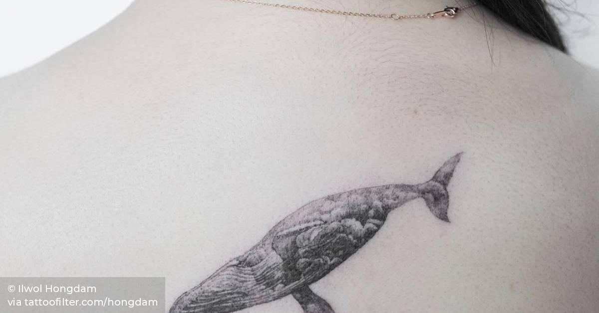 Whale cloud tattoo on the upper back.