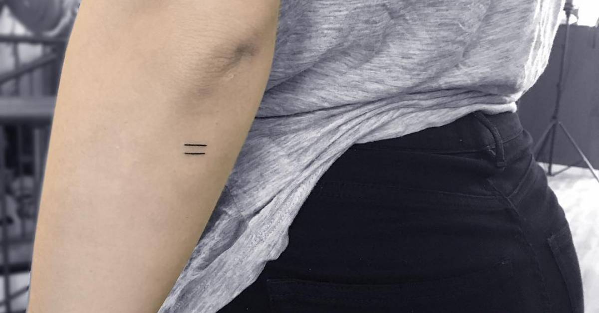 Equal sign tattoo on the left forearm.