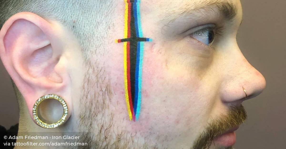 Dagger anaglyph tattoo on the right side of the face.