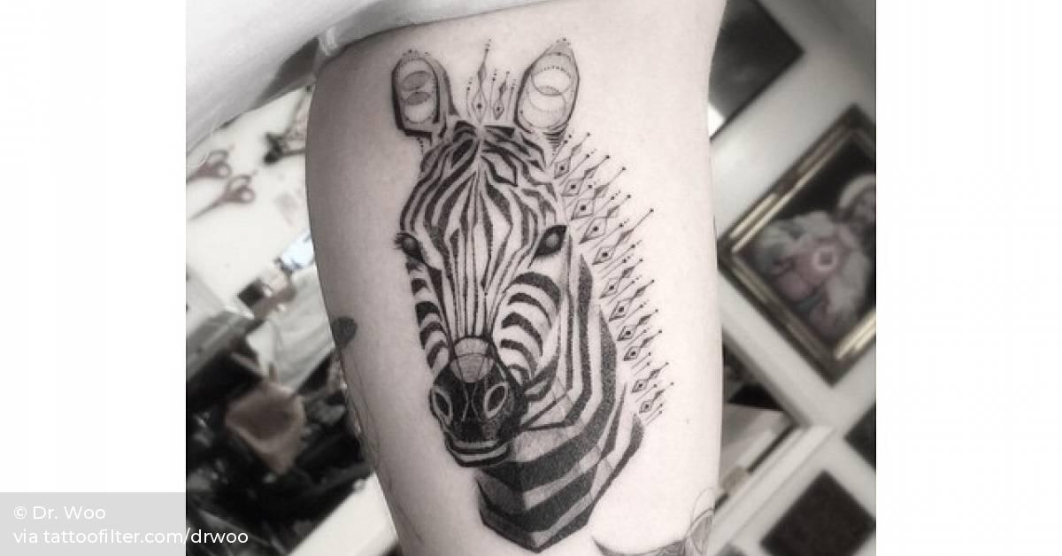 Single needle zebra tattoo on the left inner arm.