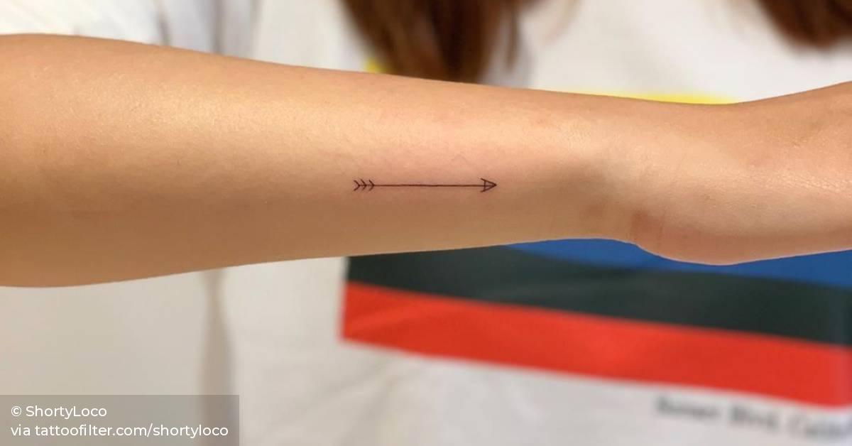 Arrow tattoo on the wrist.