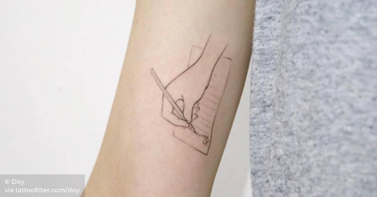 Writting hand tattoo on the right inner forearm.
