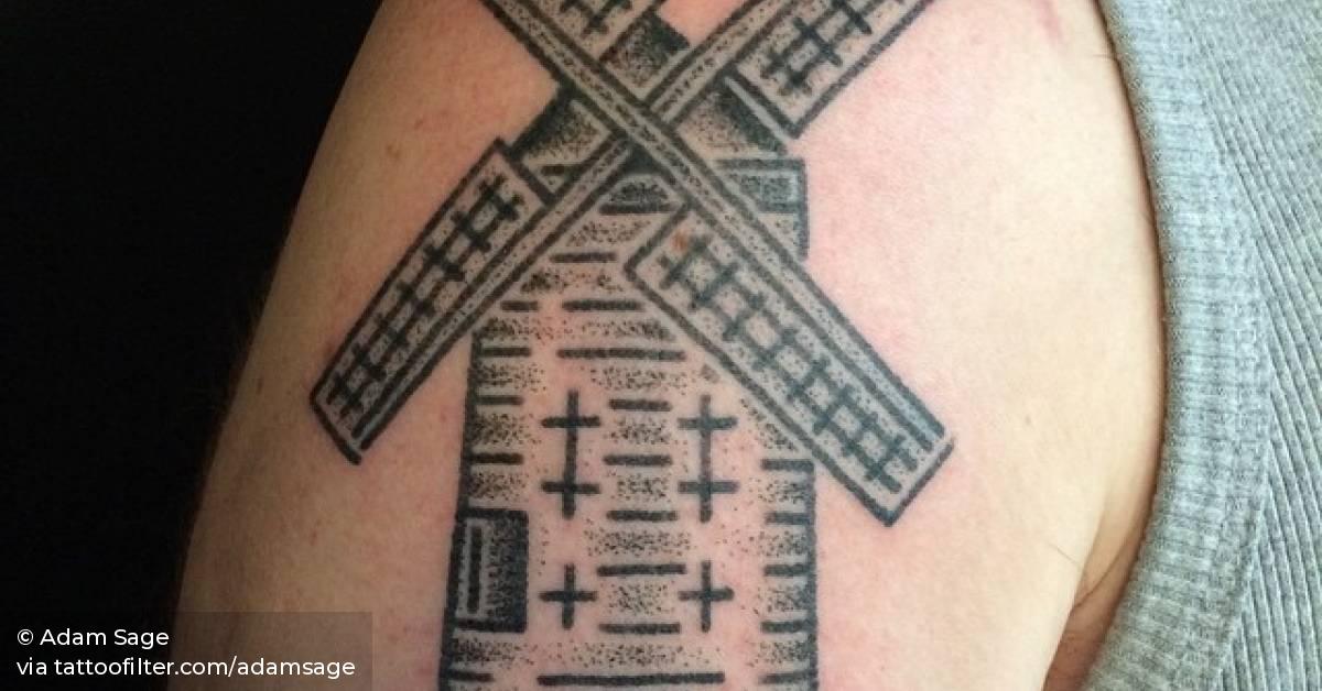 Hand poked windmill tattoo on the right shoulder.