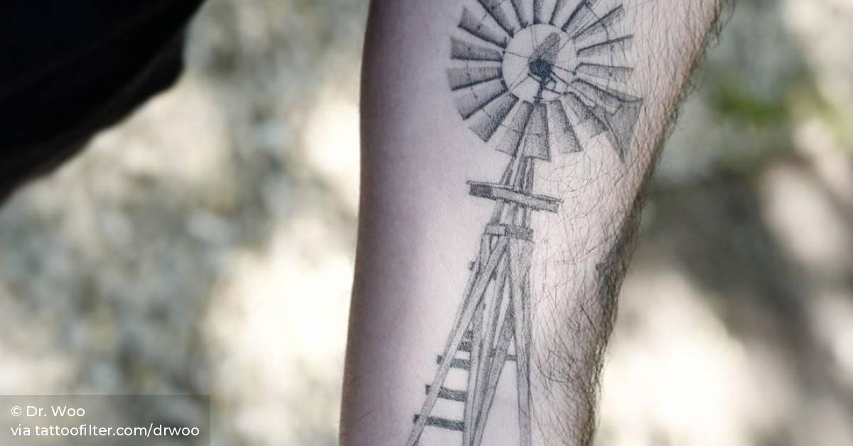 Healed single needle windpump tattoo on the inner