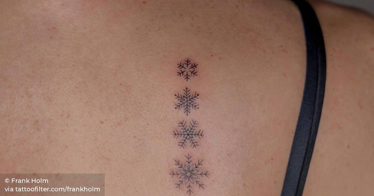 Snowflake tattoos on the upper back.