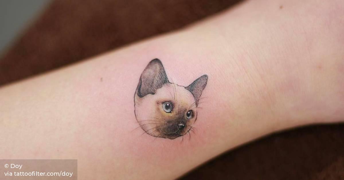 Siamese cat tattoo on the wrist.