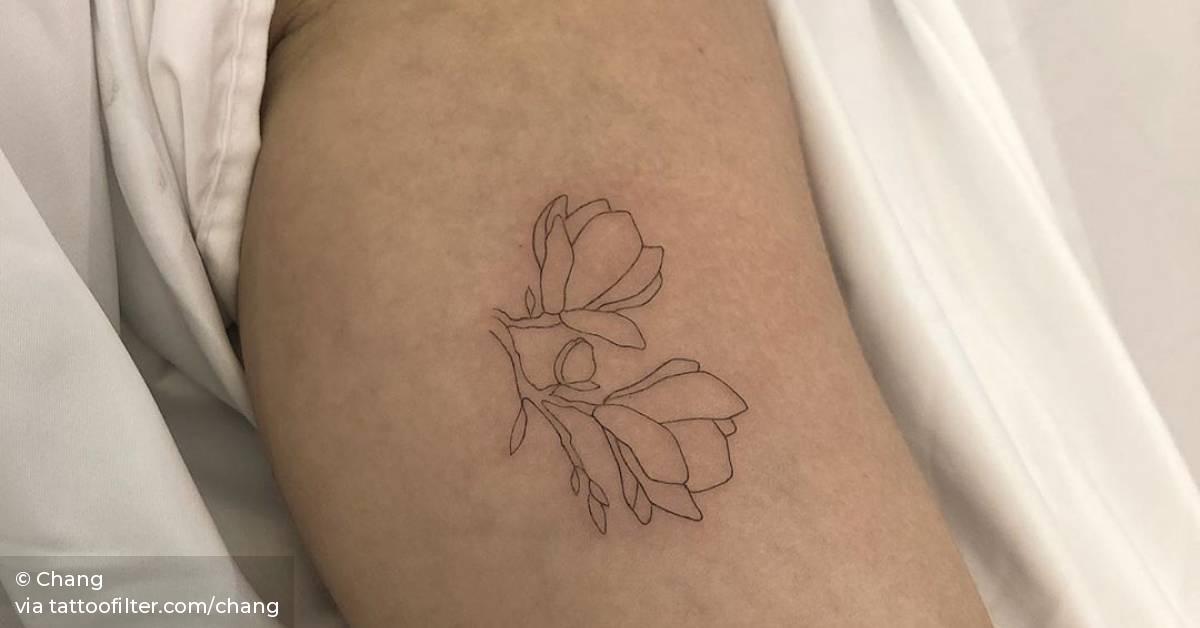 Fine line magnolia tattoo on the inner arm.
