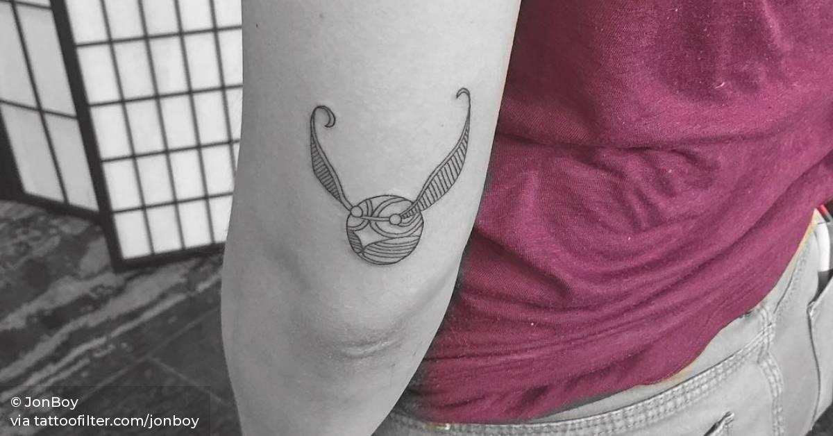 Harry Potter's golden snitch tattoo on the tricep.
