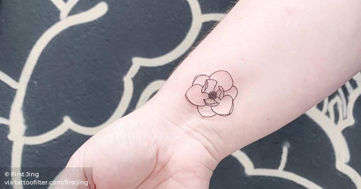 Fine line flower on the wrist.