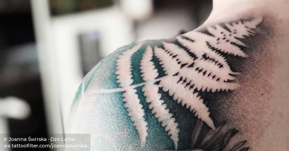Fern frond tattoo on the shoulder.