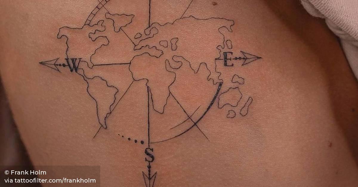 Compass rose and world map tattoo on the ribcage.