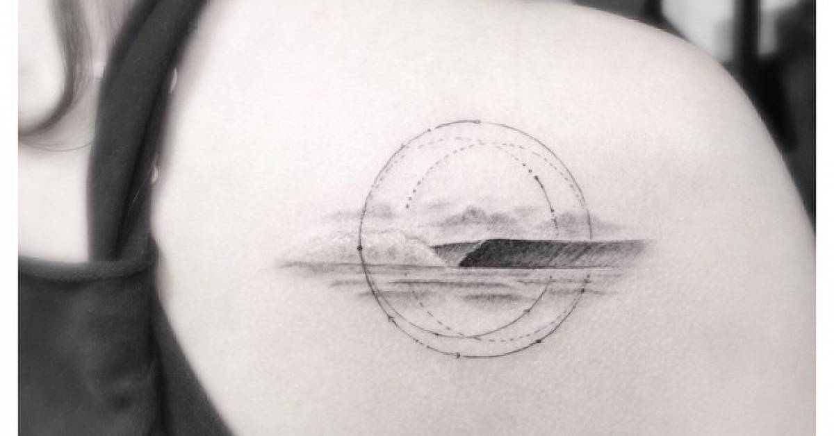 Single needle wave tattoo on the right shoulder blade.