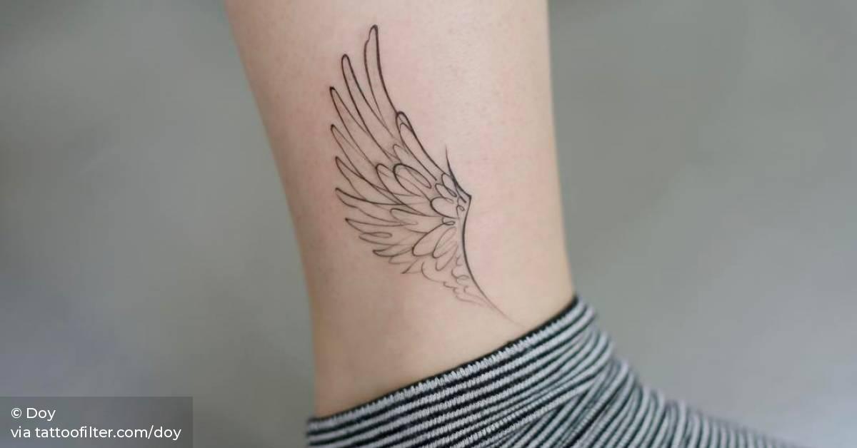 Fine line wing tattoo on the ankle.
