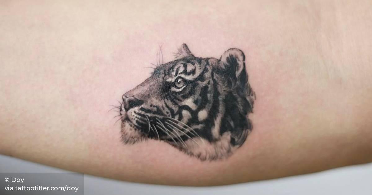 Fine line style tiger head tattoo on the right inner