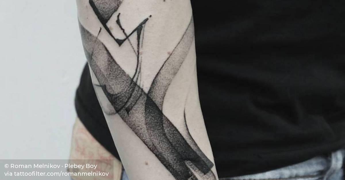 Abstract tattoo on the right forearm.