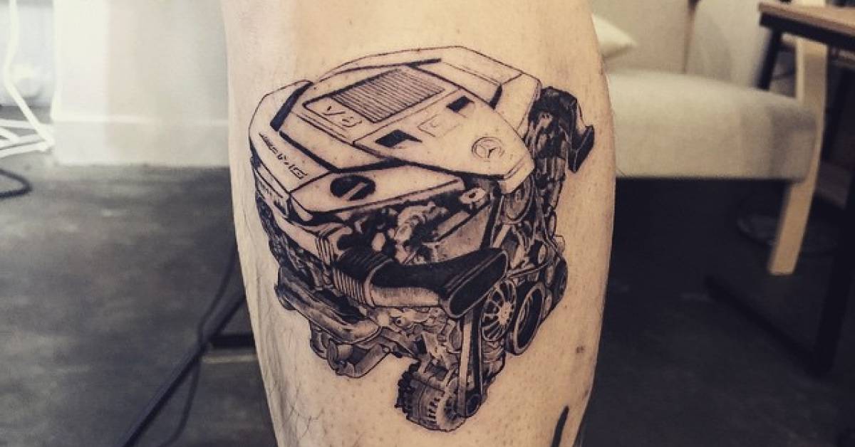 Mercedes Benz Amg V8 engine tattoo on the left shin.