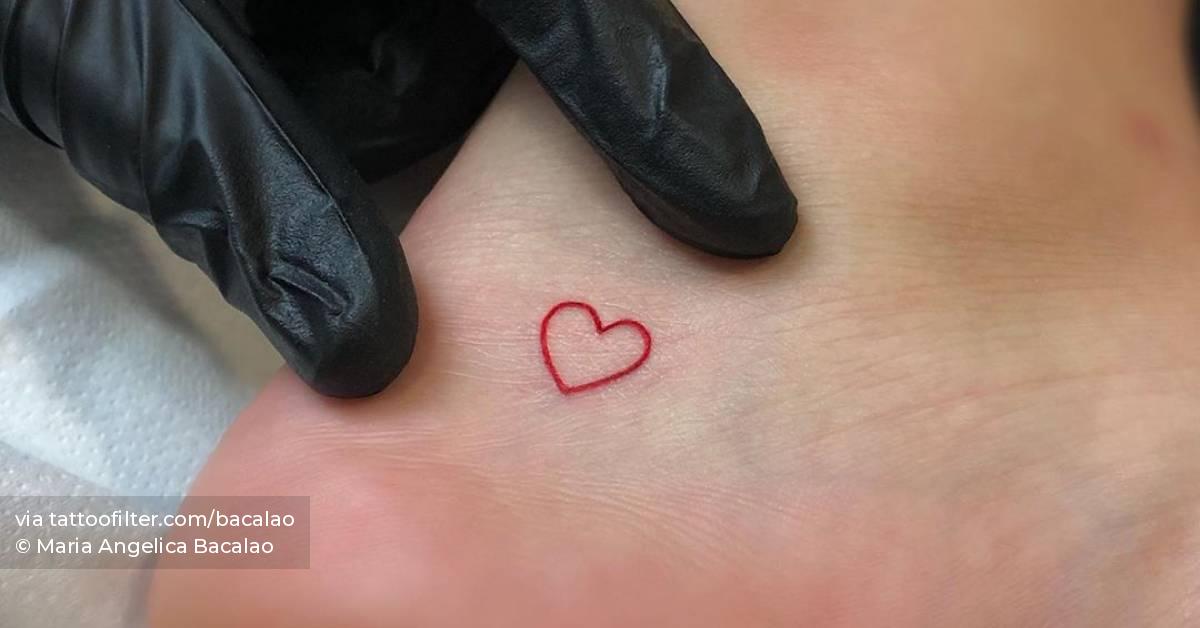 Red heart tattoo on the ankle.