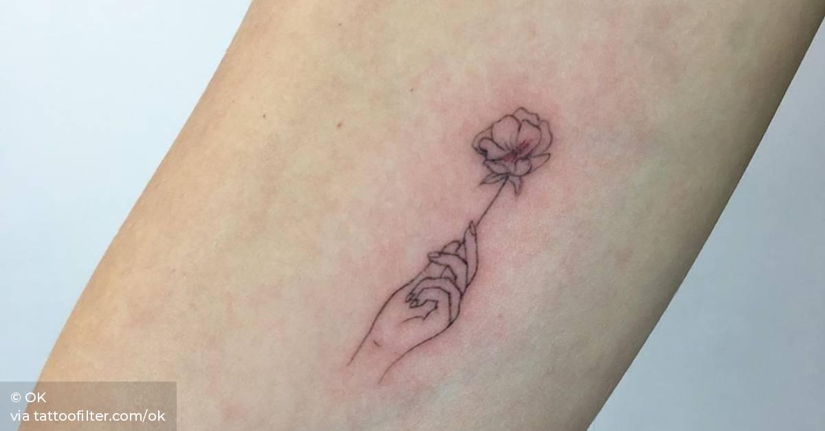 Flower holding hand tattoo.