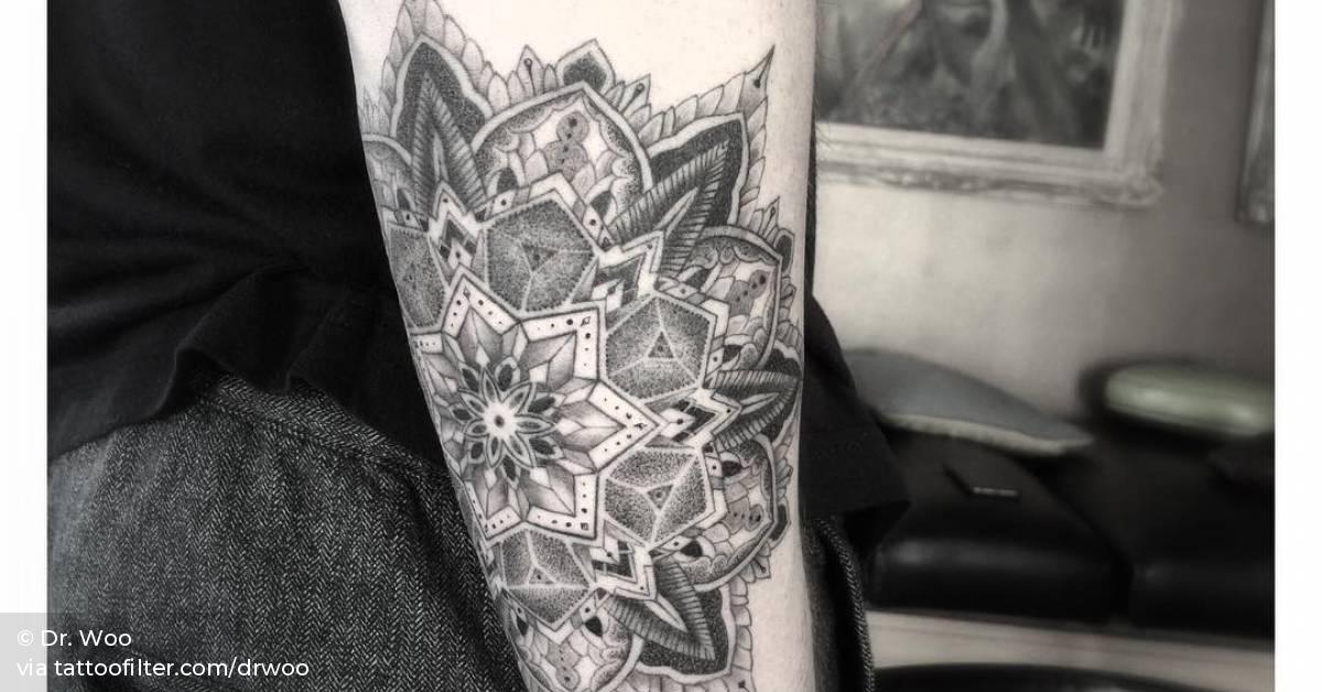 Fine line style mandala on the forearm.