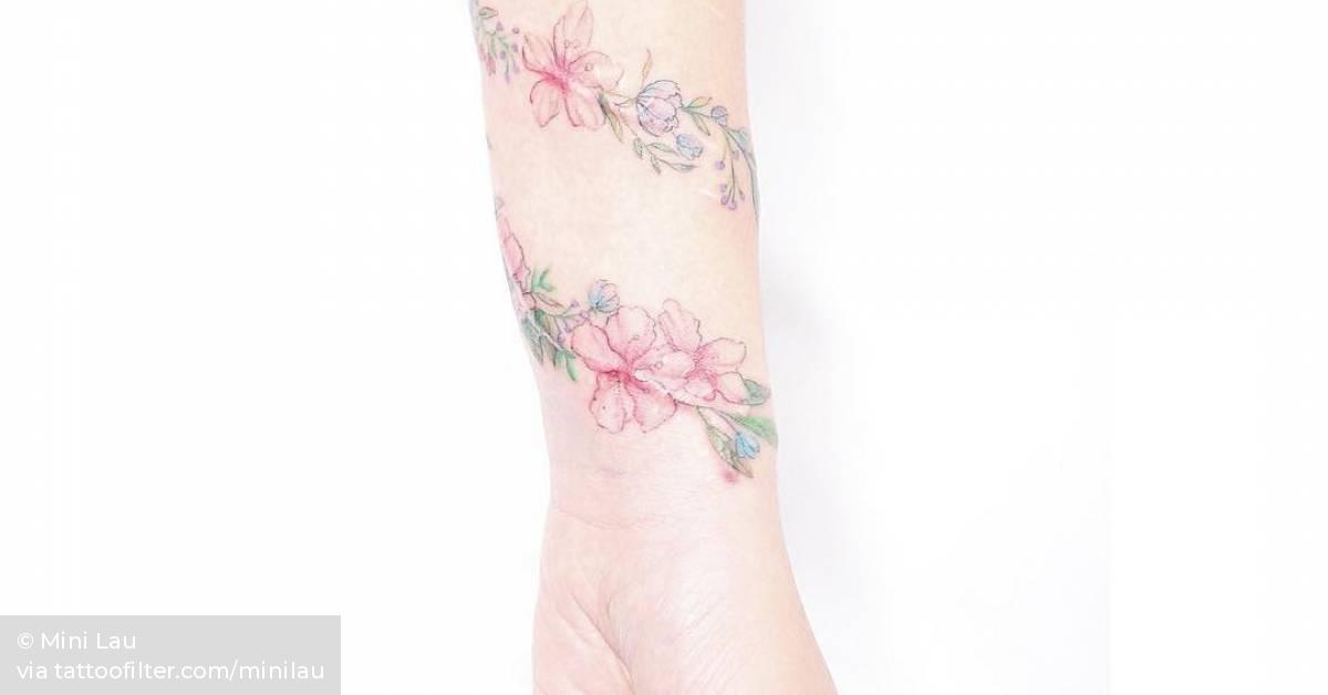 Flower bracelet scar cover tattoo.