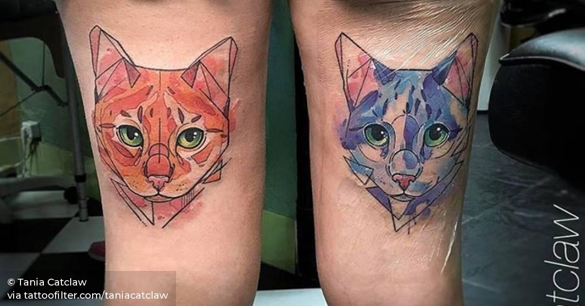 Matching cat head tattoos.