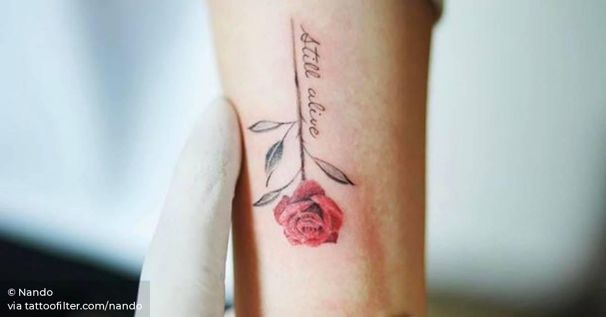 Red rose tattoo on the forearm.