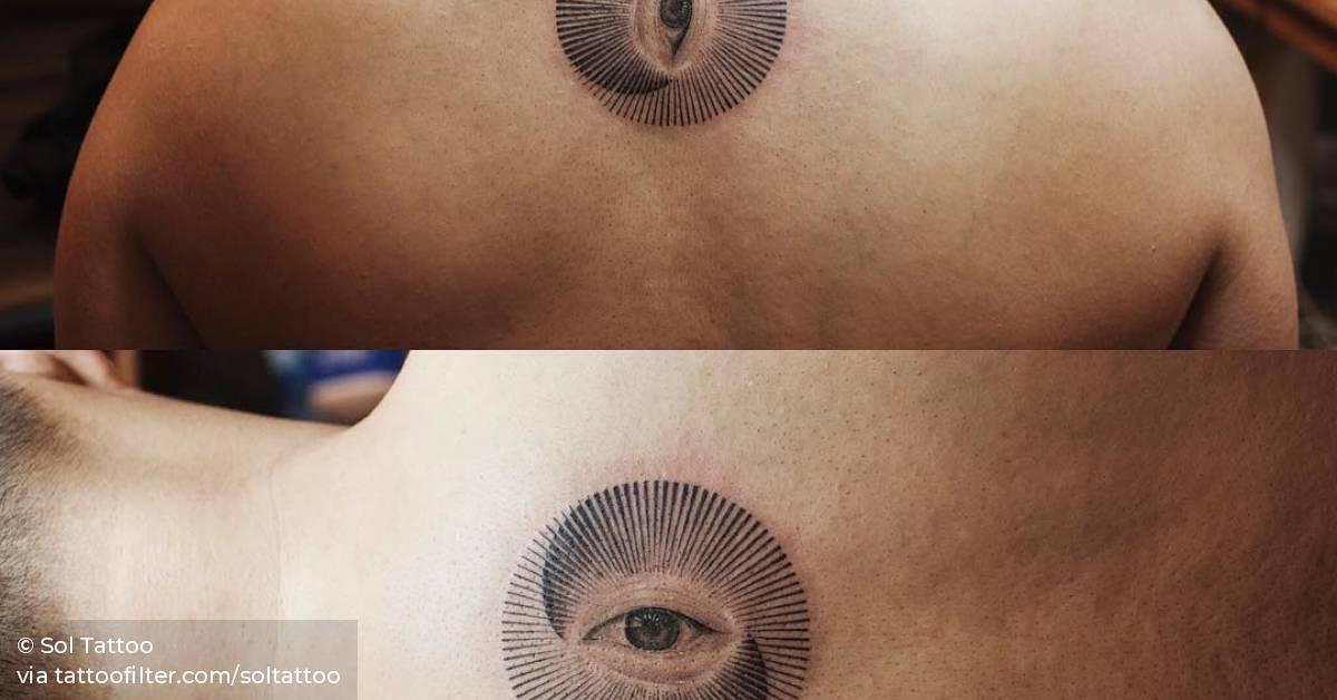 Wife's eye tattoo on the upper back.