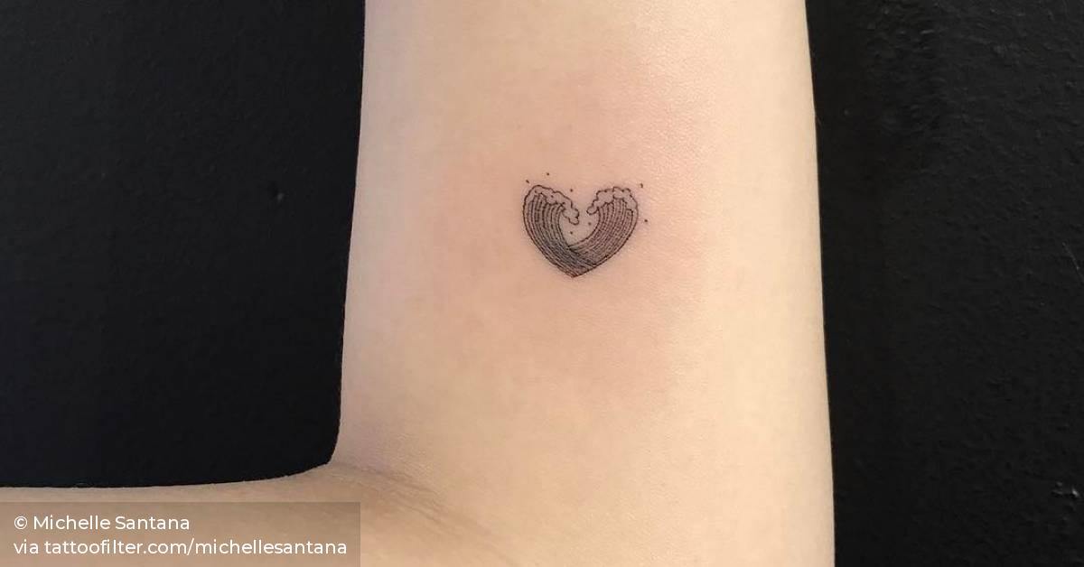 Heart wave tattoo on the left forearm.
