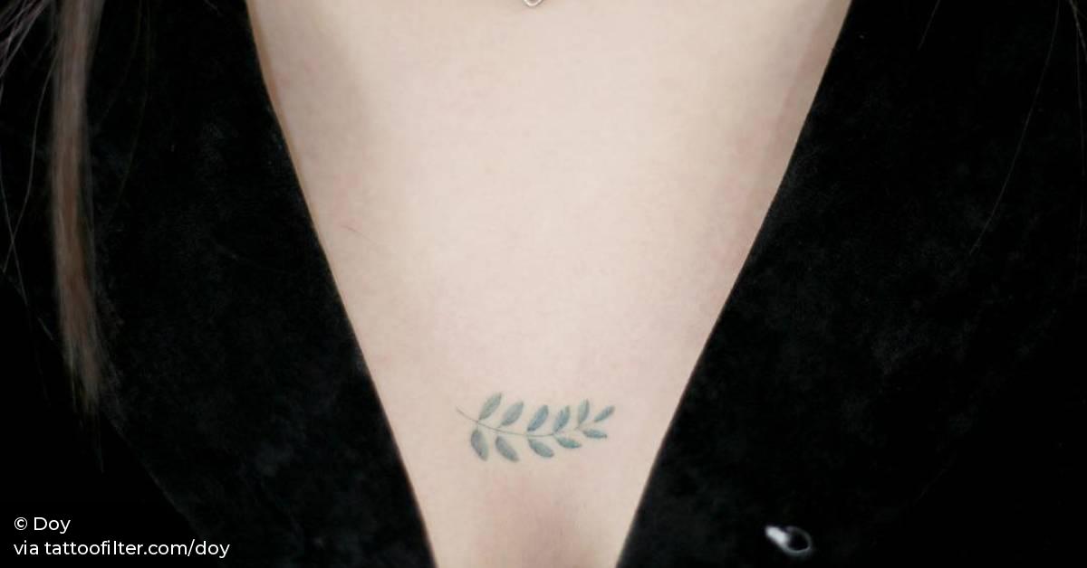 Tiny leaf tattoo on the chest.