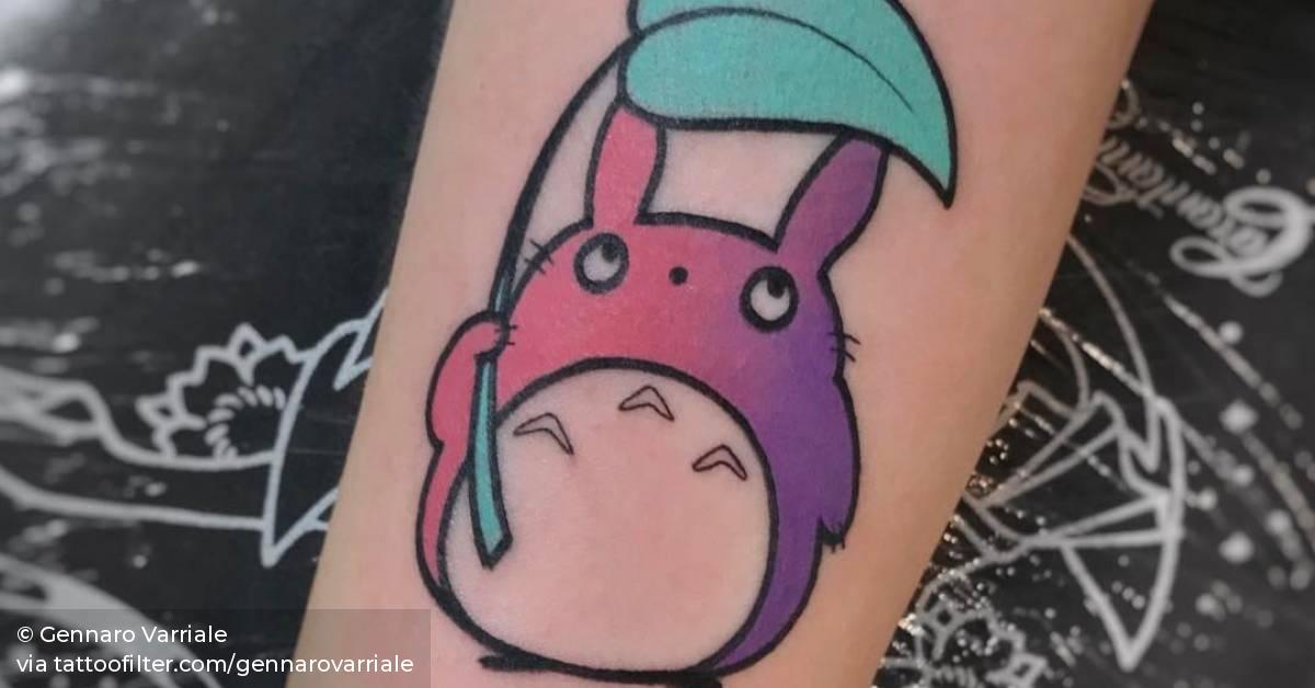 Totoro tattoo on the upper arm.