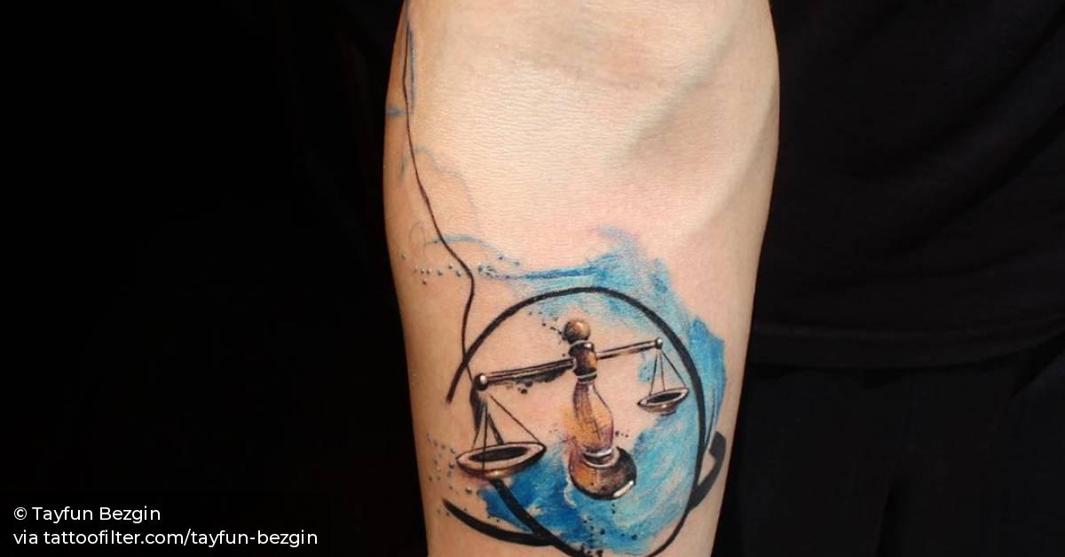 Watercolor style balance tattoo on the right inner