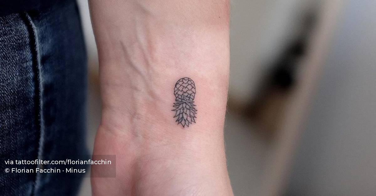 Fine line pineapple tattoo on the wrist.