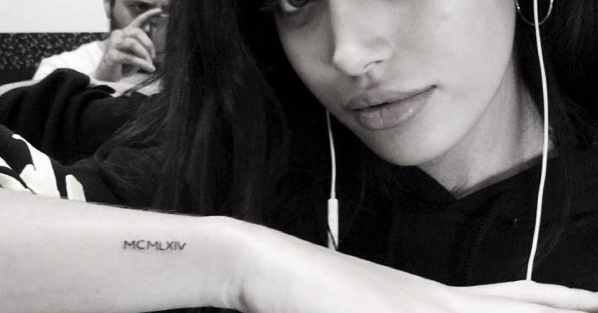 MCMLXIV tattoo in on Cindy Kimberly's right wrist.