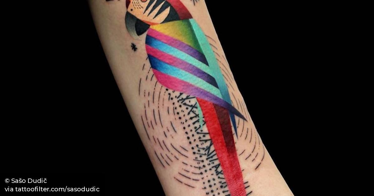 Parrot tattoo on the left arm.