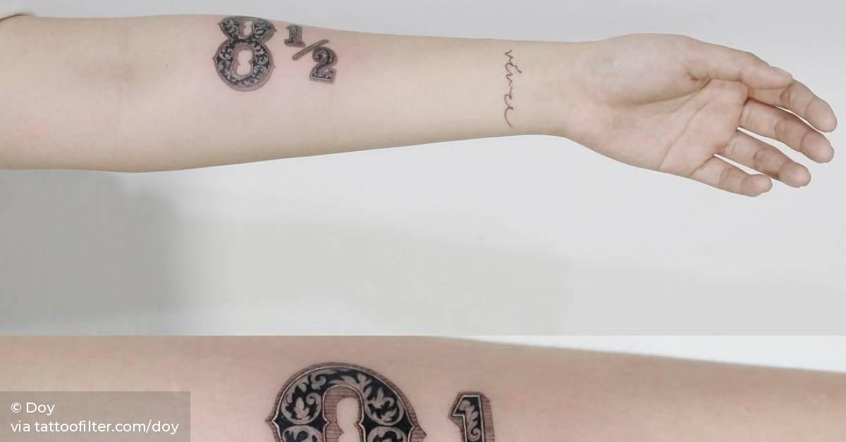 8½ tattoo on the left forearm.