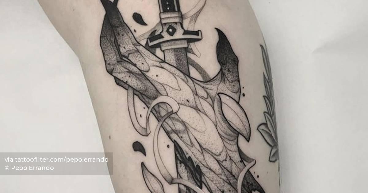 Hand + dagger tattoo on inner arm