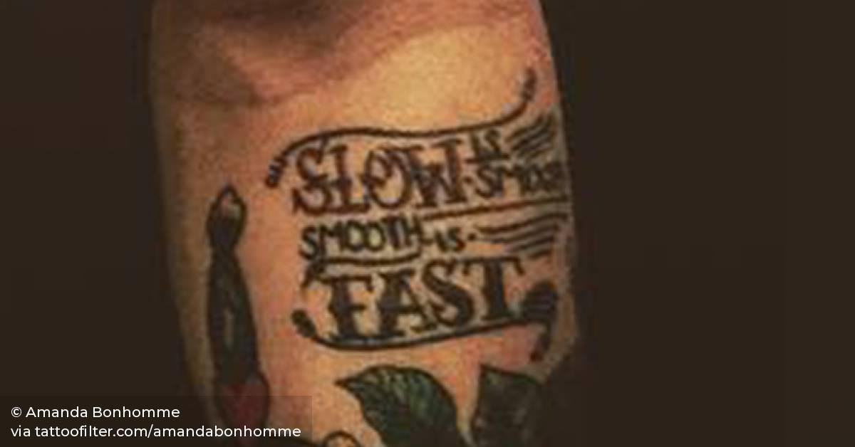 "Slow is smooth, smooth is fast" tattoo on the left